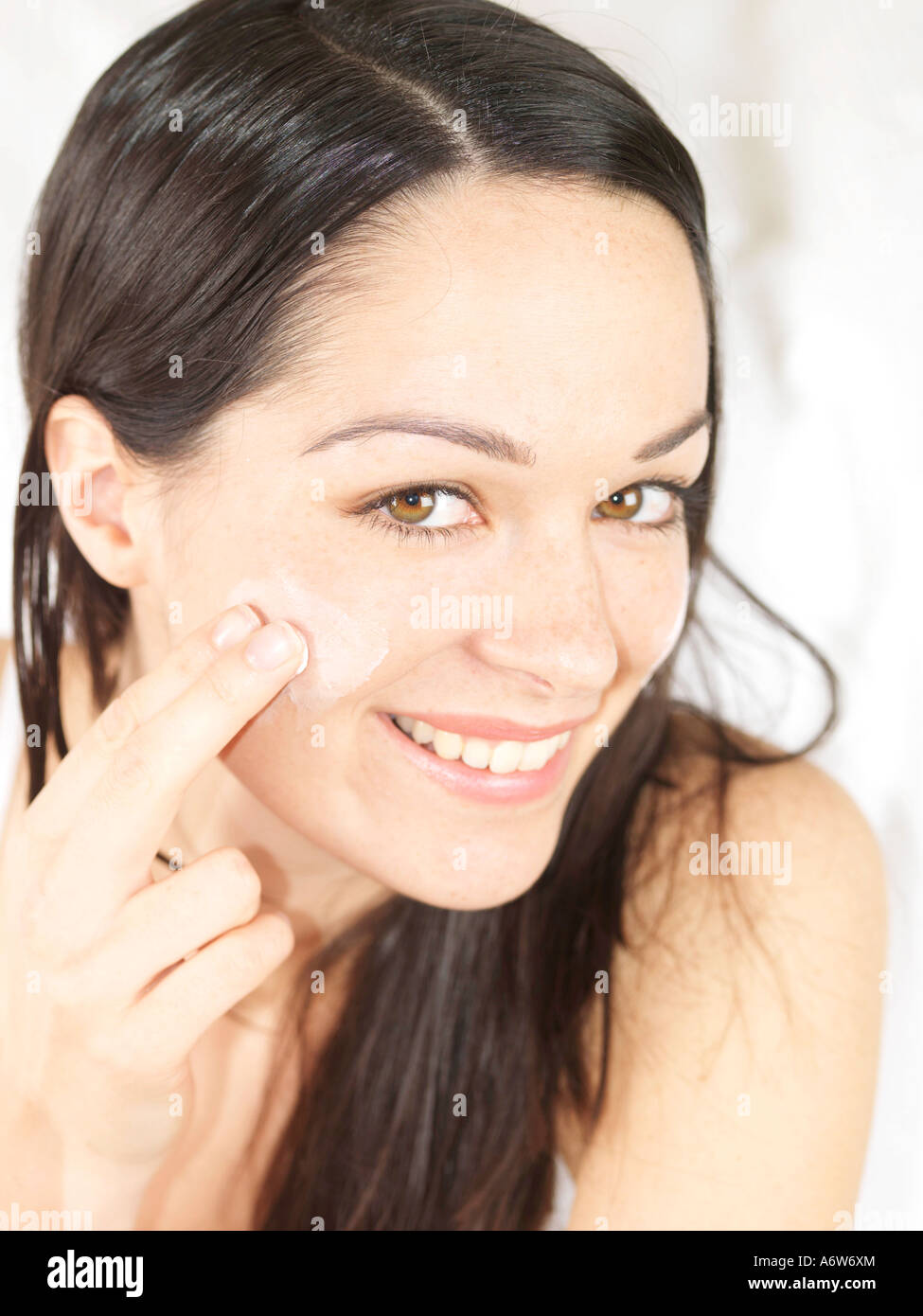 Young Woman Applying Face Cream Model Released Stock Photo - Alamy