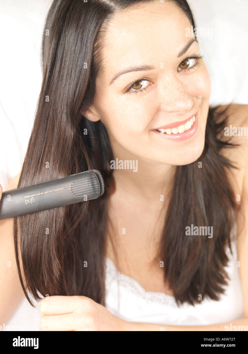 Young Woman Using Hair Straighteners Model Released Stock Photo - Alamy