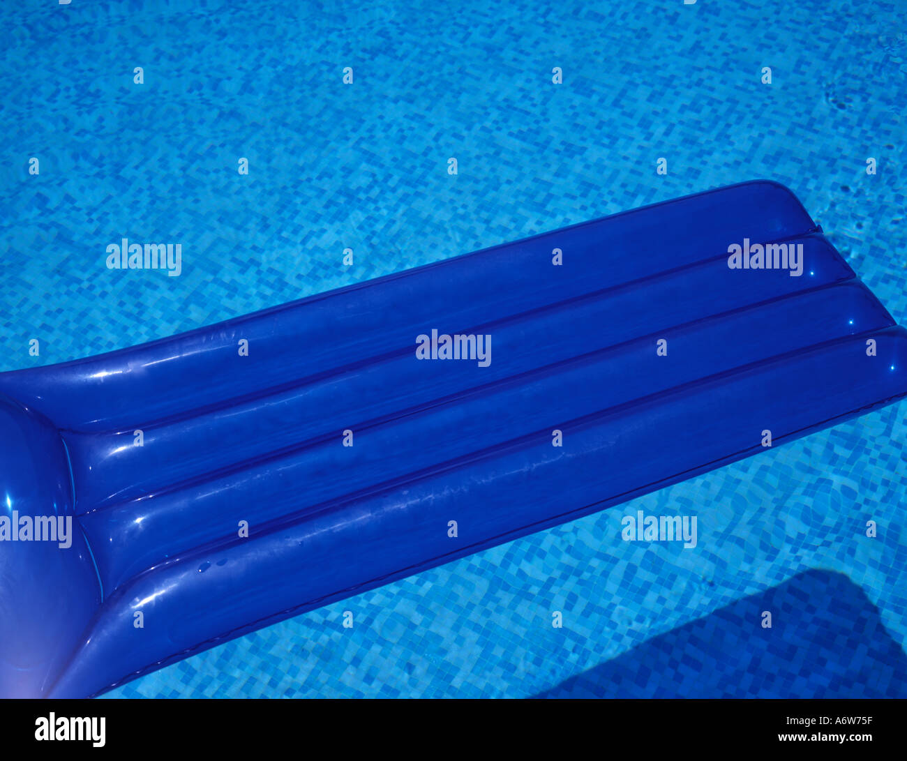 Blue lilo floating on tiled blue private villa pool in southern France ...