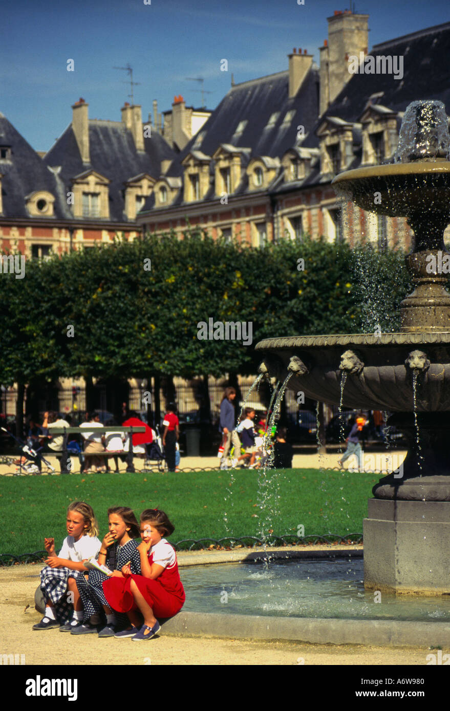 France Paris 4em Place des vosges 3 young girl eating biscuits sitting ...