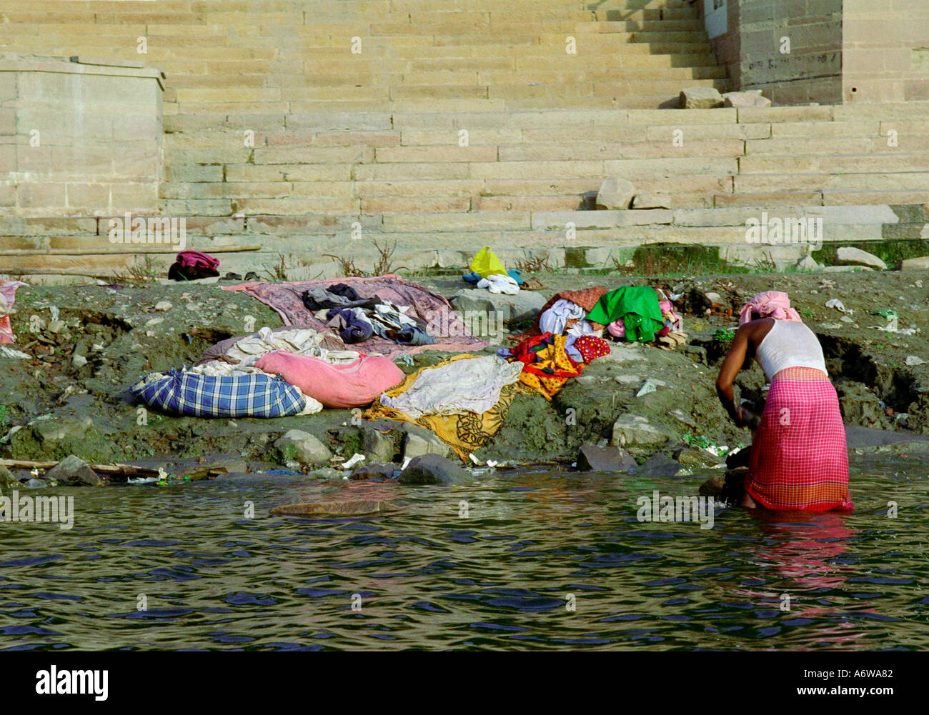 Man washing clothes in the Ganges river Varanasi India Stock Photo - Alamy