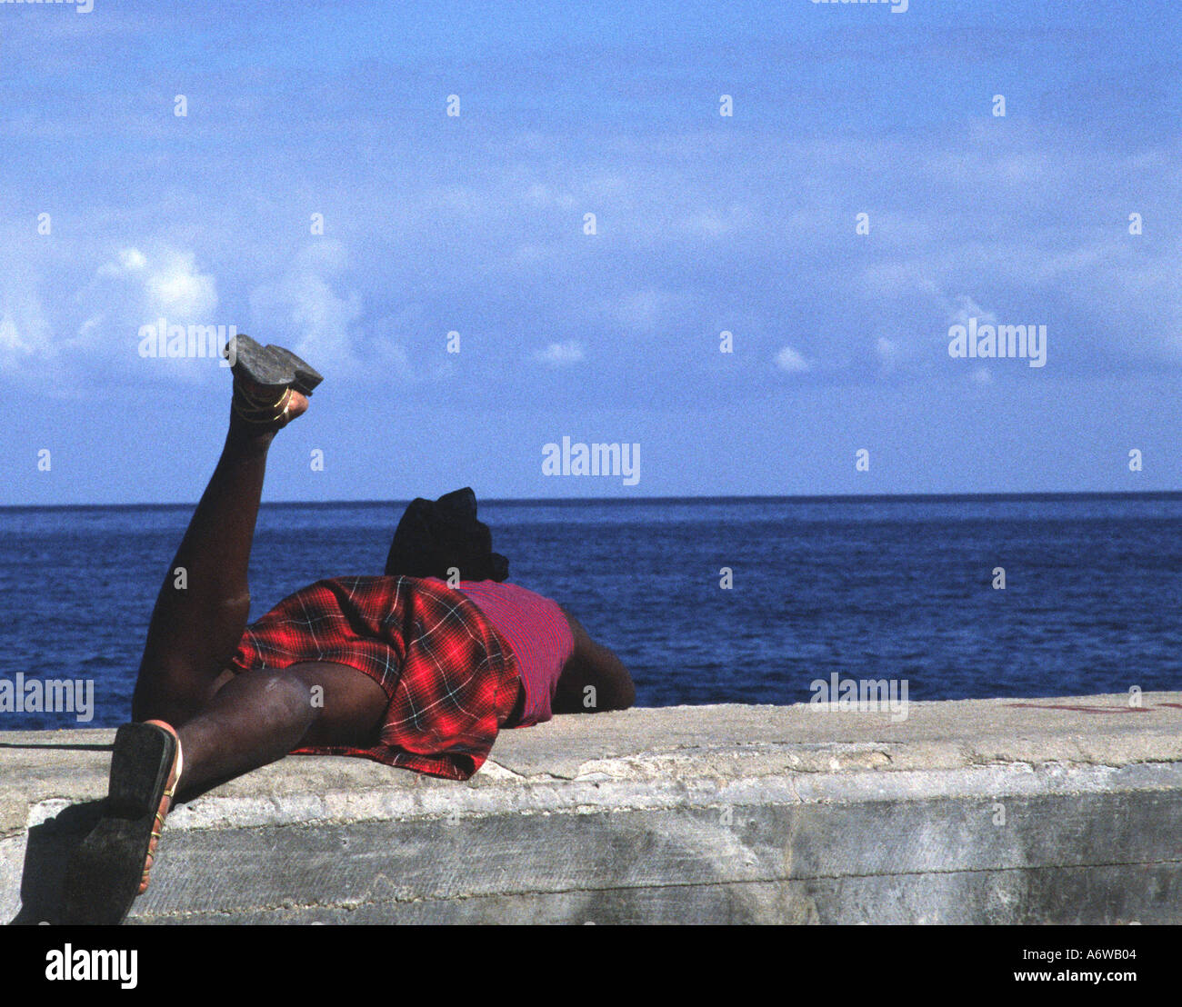 Girl lying on fence The Malecon Havana Cuba Stock Photo - Alamy