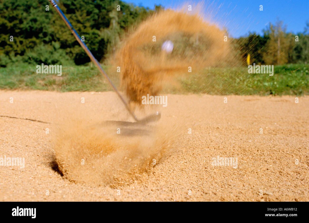 Golf ball in flight from sand trap towards green Stock Photo - Alamy