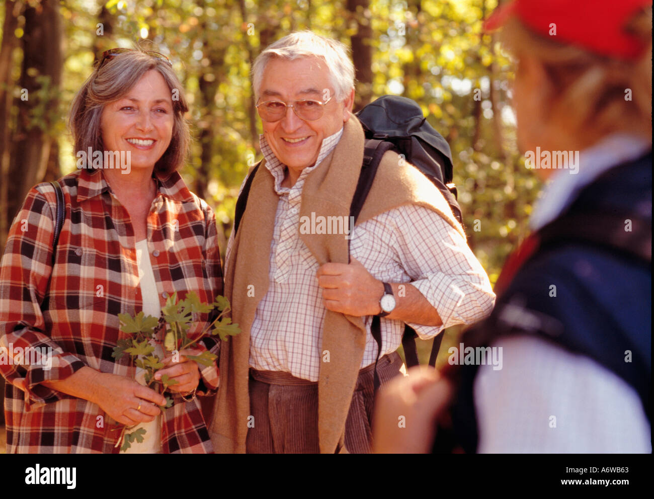 Mature couple rambling over shoulder of another woman in foreground ...