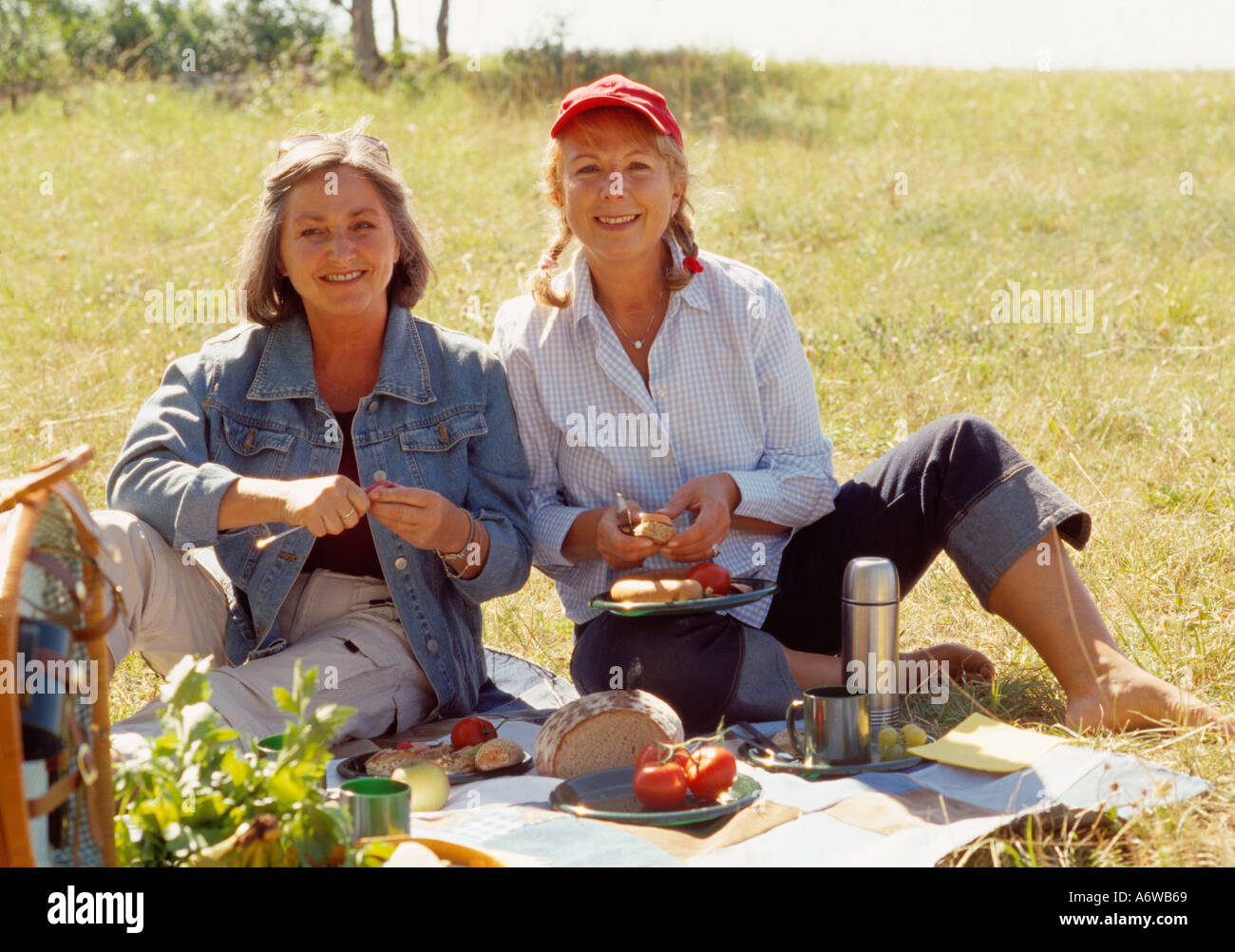 Two mature women having a picnic Stock Photo - Alamy