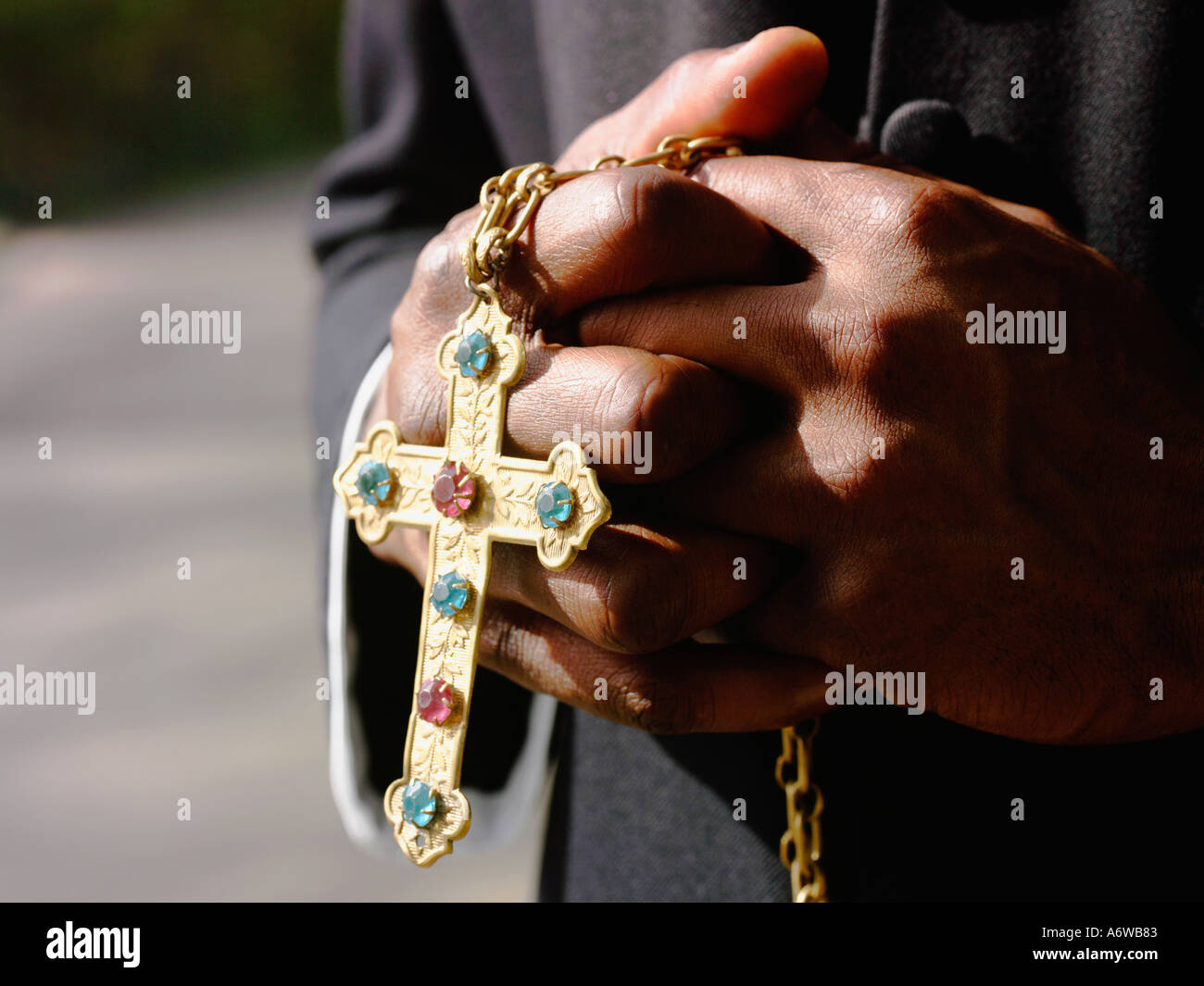 African hands holding cross Stock Photo - Alamy