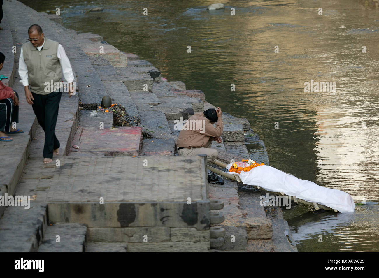 Pashupatinath, a dead body is dippped in the holy water of the Bagmati ...