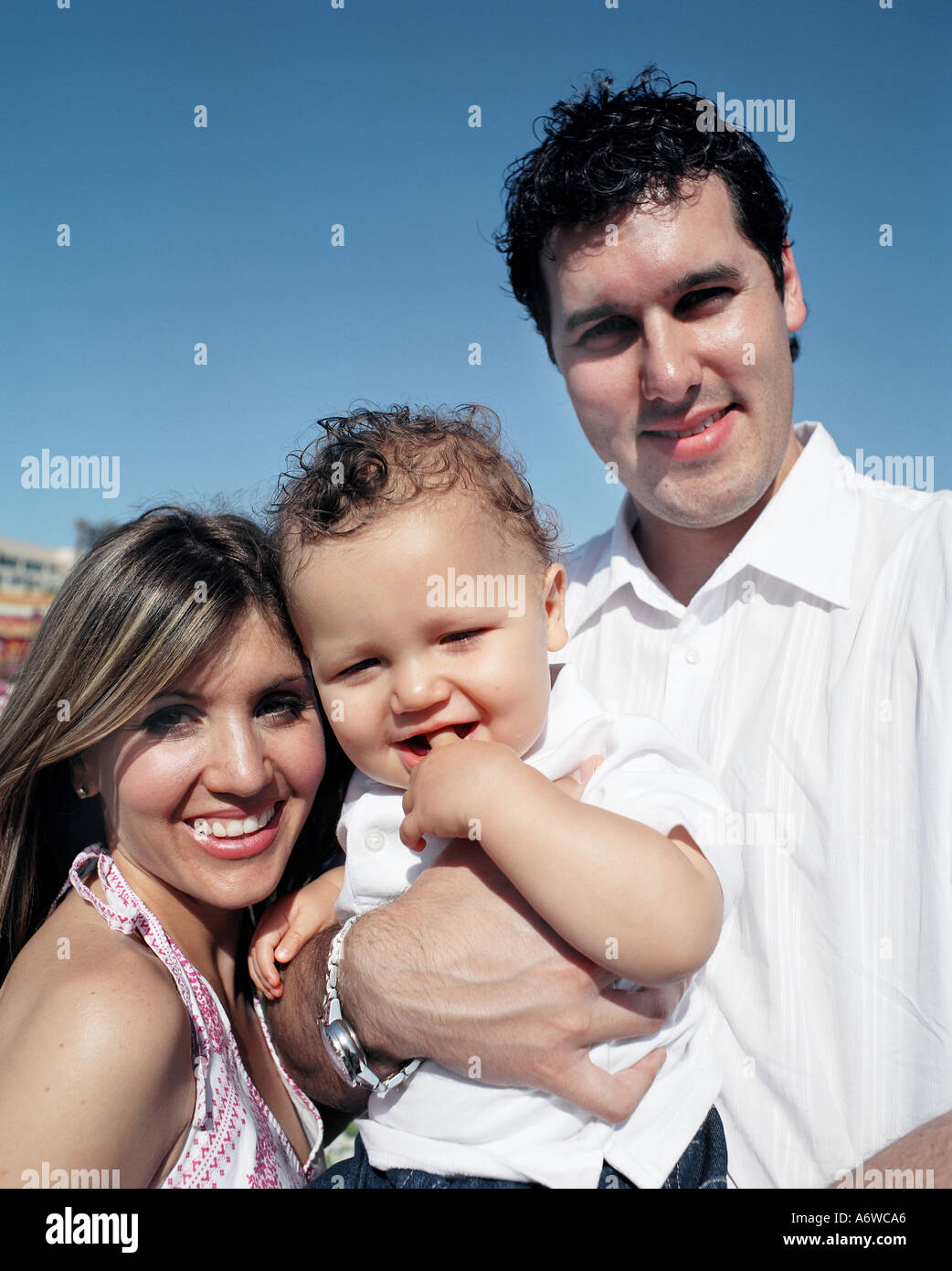 Family in field of flowers Stock Photo - Alamy