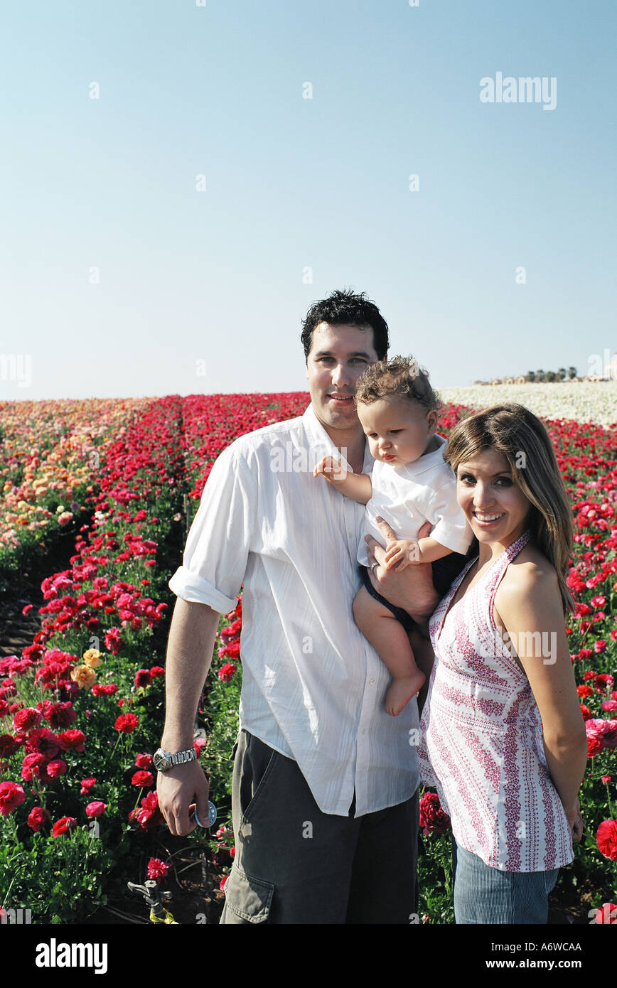 Family in field of flowers Stock Photo - Alamy