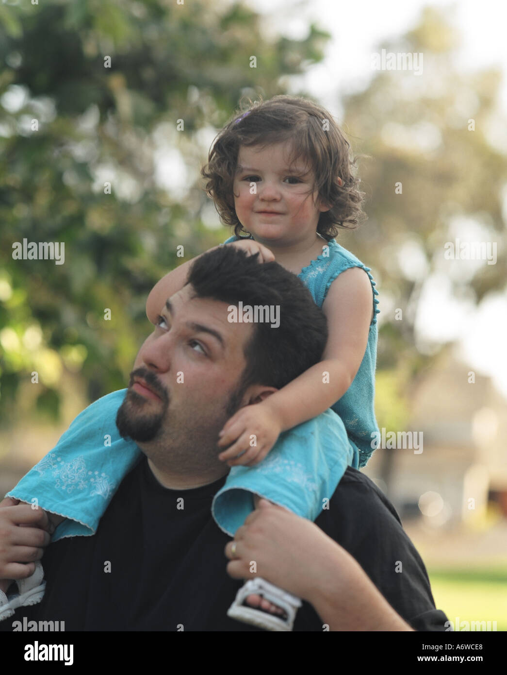 Happy child on her Fathers shoulders Stock Photo - Alamy