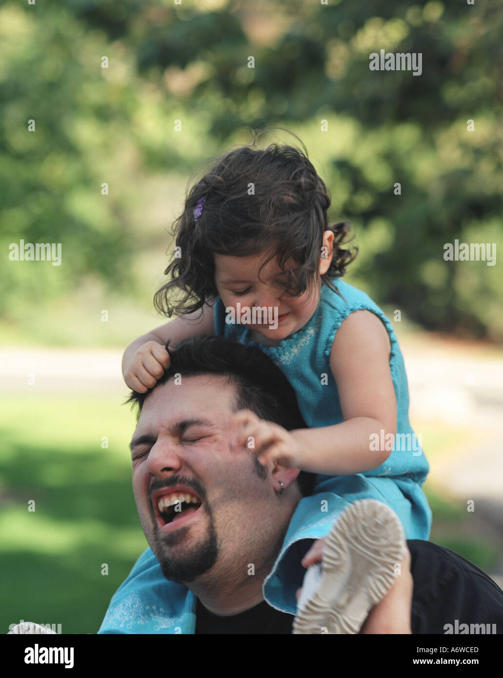 Happy child on her Fathers shoulders Stock Photo - Alamy