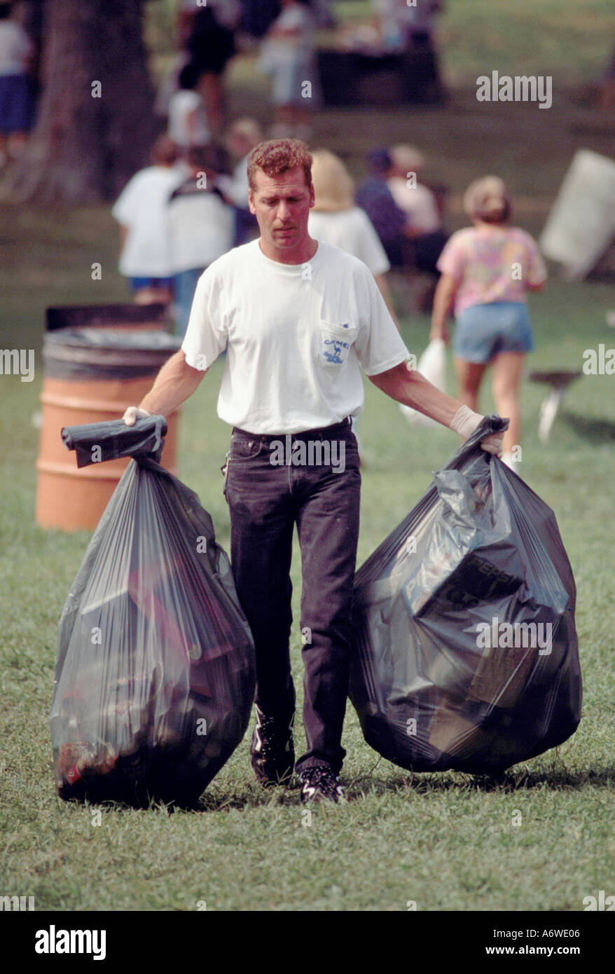 Taking trash to the dumpster at church gathering Stock Photo - Alamy