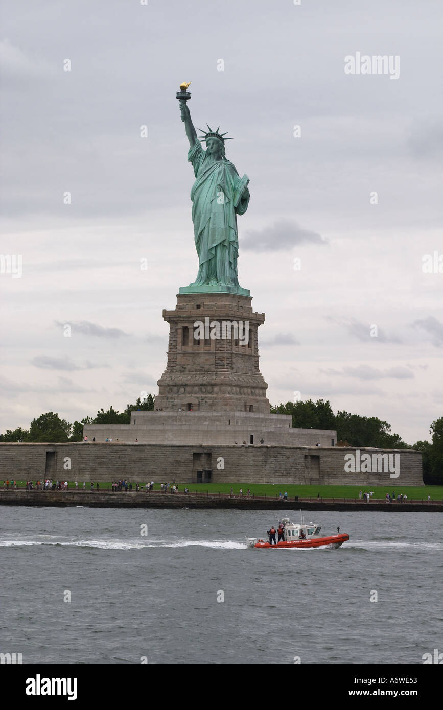 US Coast Guard gunboat patrolling in front of the Statue of Liberty ...