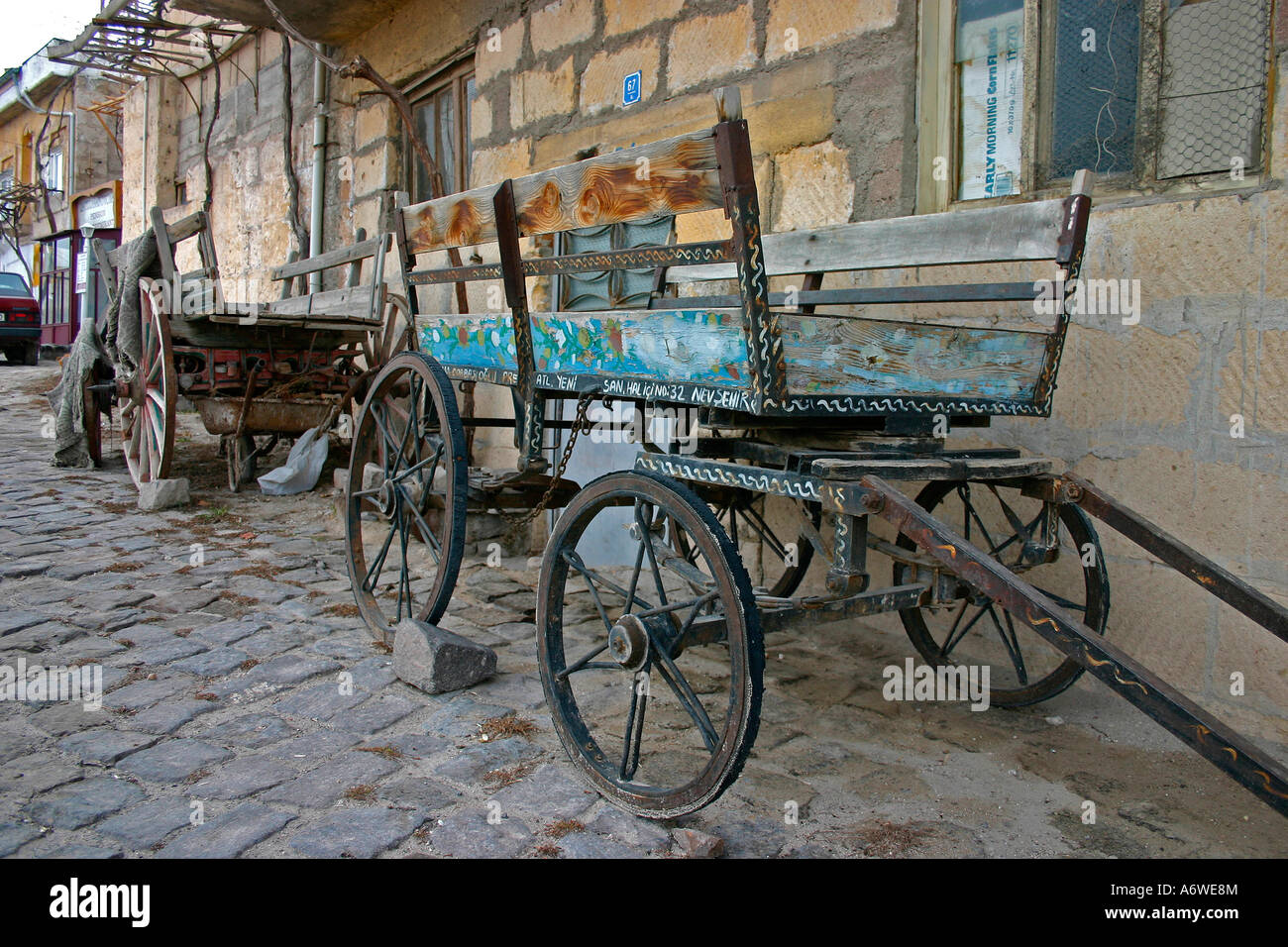 Traditional horse-pulled wagons are parked by the side of the road in ...