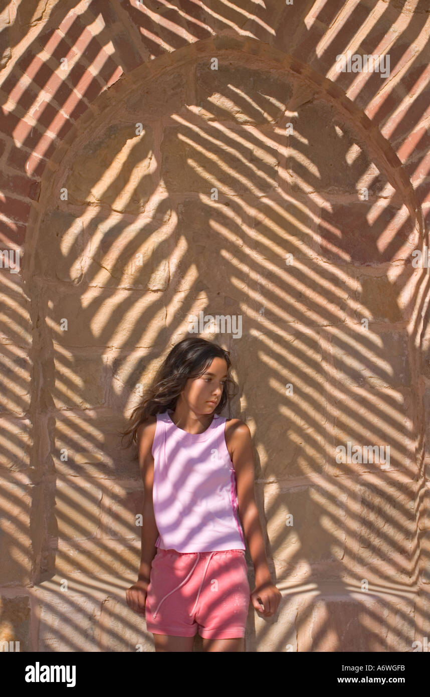Latticework Shadows on Young Girl Standing Under Stone Archway Stock ...