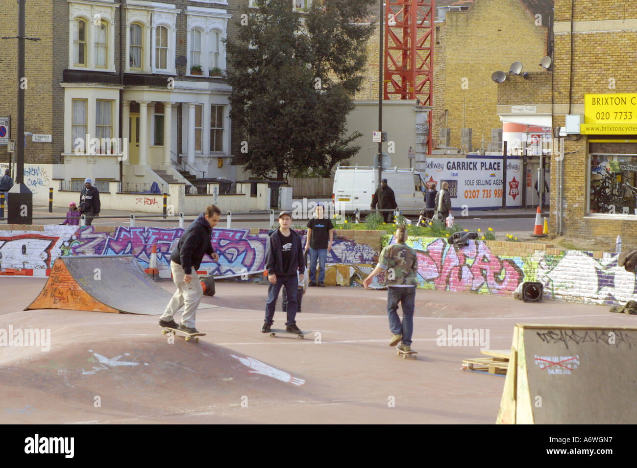 BMX bike and skateboarder playing in community playground Stock Photo ...