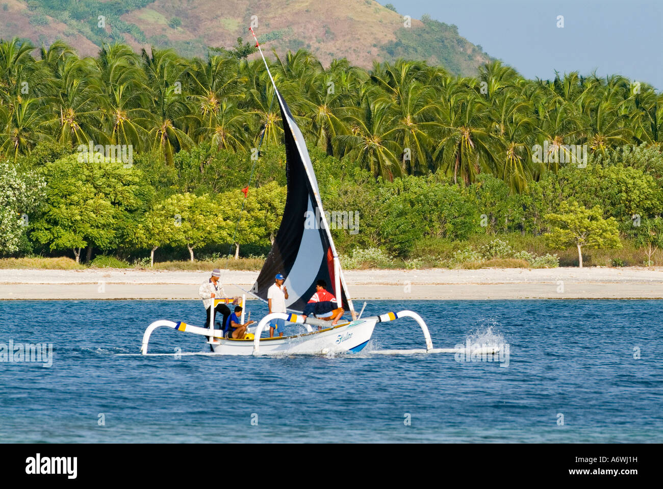 boat sailing from tropical island Stock Photo - Alamy
