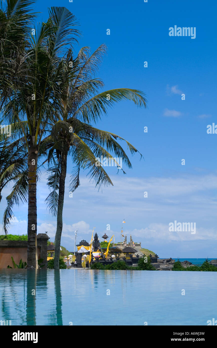 swimming pool with coconut tree and temple in the background Stock ...
