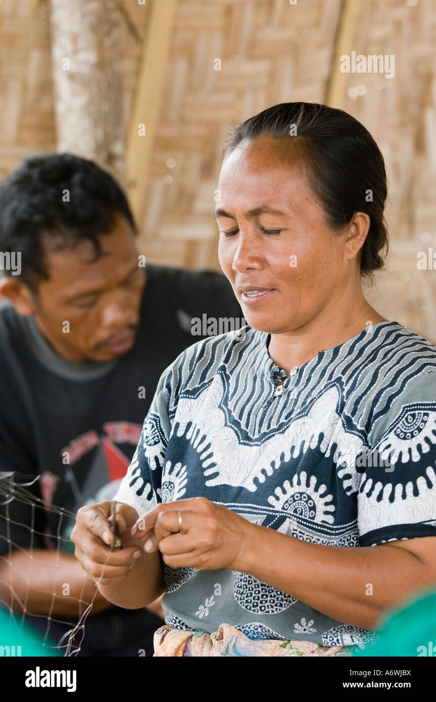 couple weaving fishing net Stock Photo - Alamy