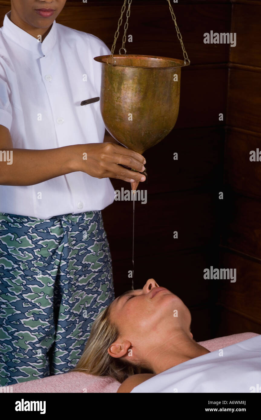 woman receiving spa oil head treatment Stock Photo - Alamy