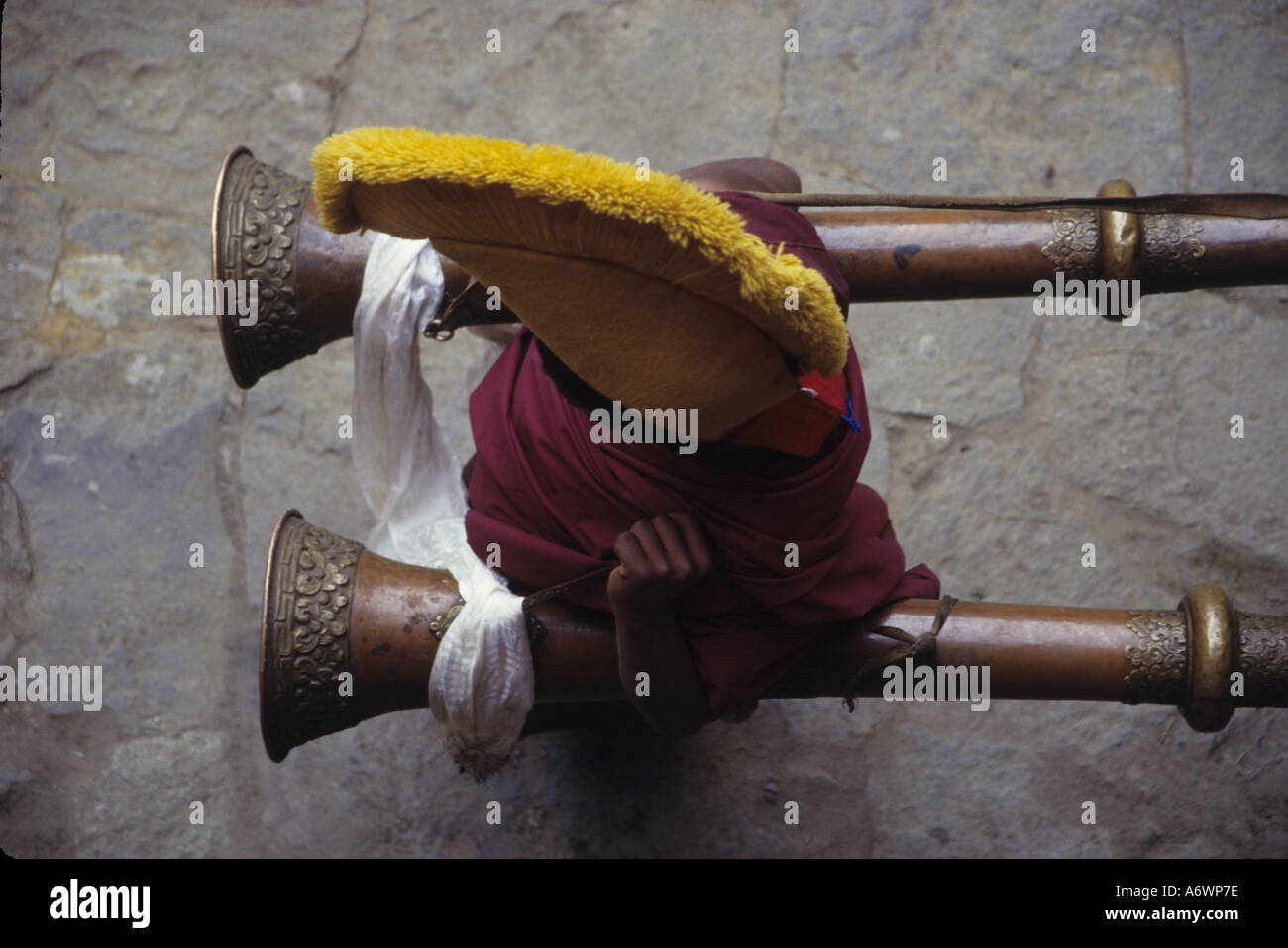 Nepal, Tengboche Monastery. Yellow-hat lama (Buddhist monk) carrying ...