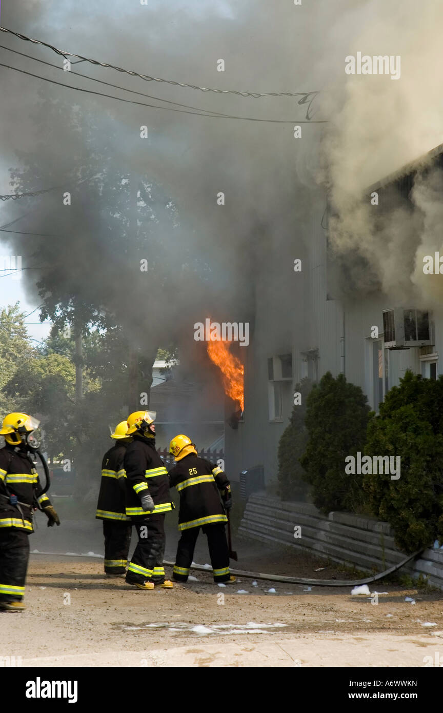 Firefighters fighting flame of a building in Quebec country, Canada ...