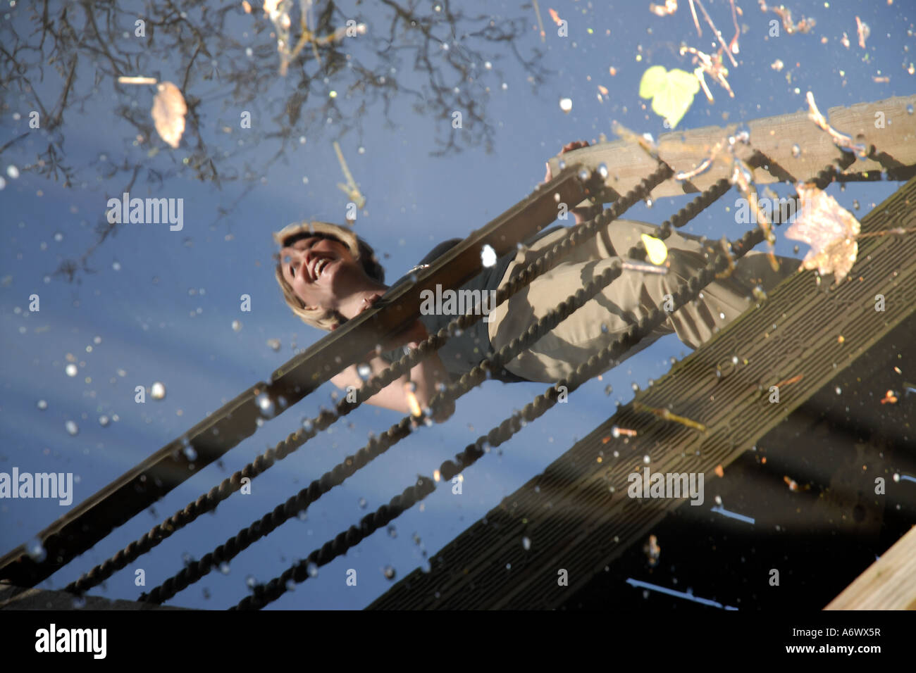 Reflection of lady in water Stock Photo - Alamy