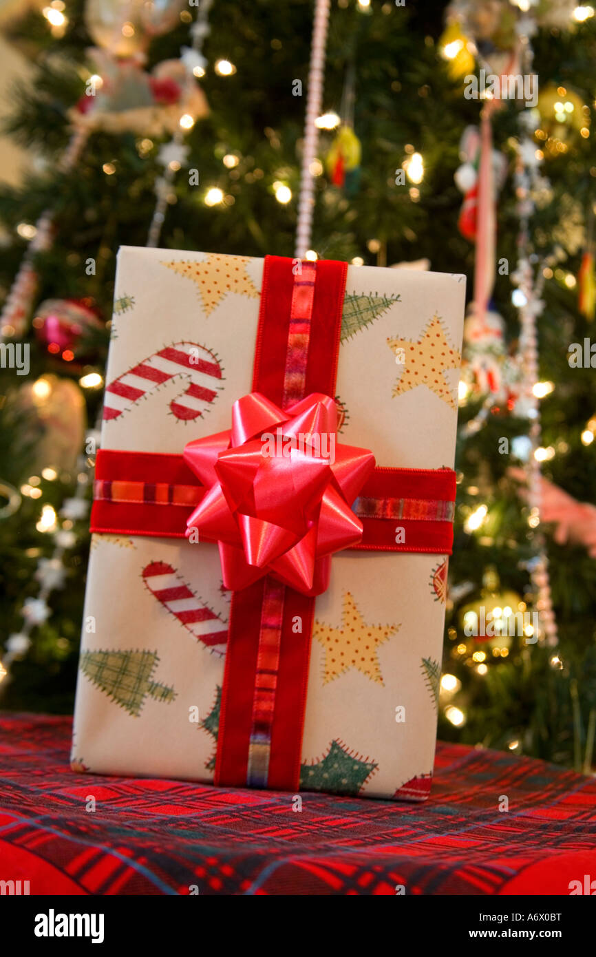 A Christmas present by the Christmas tree Stock Photo - Alamy