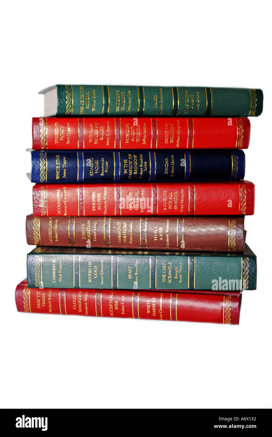 A Vertical stack of colored leather bound books against a white ...