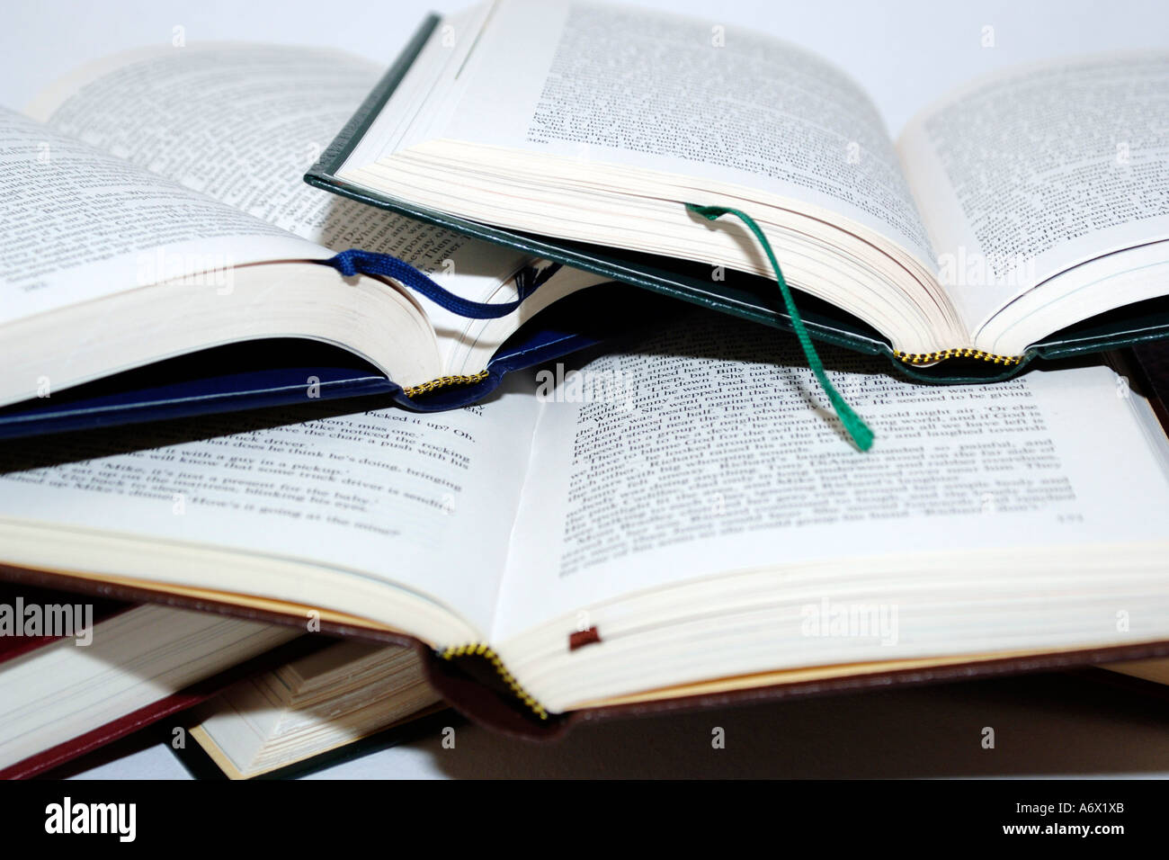 A stack of open books against a white background Stock Photo - Alamy