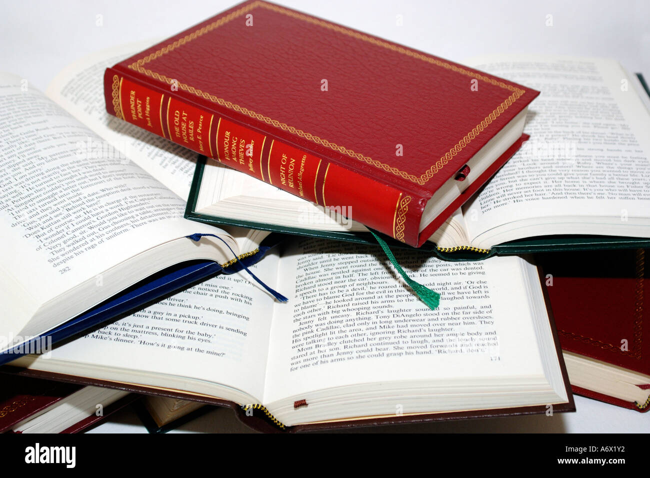 A stack of open books against a white background Stock Photo - Alamy