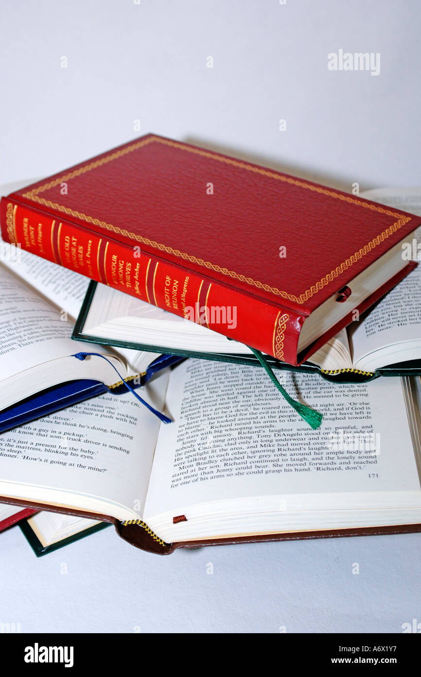 A stack of open books against a white background Stock Photo - Alamy