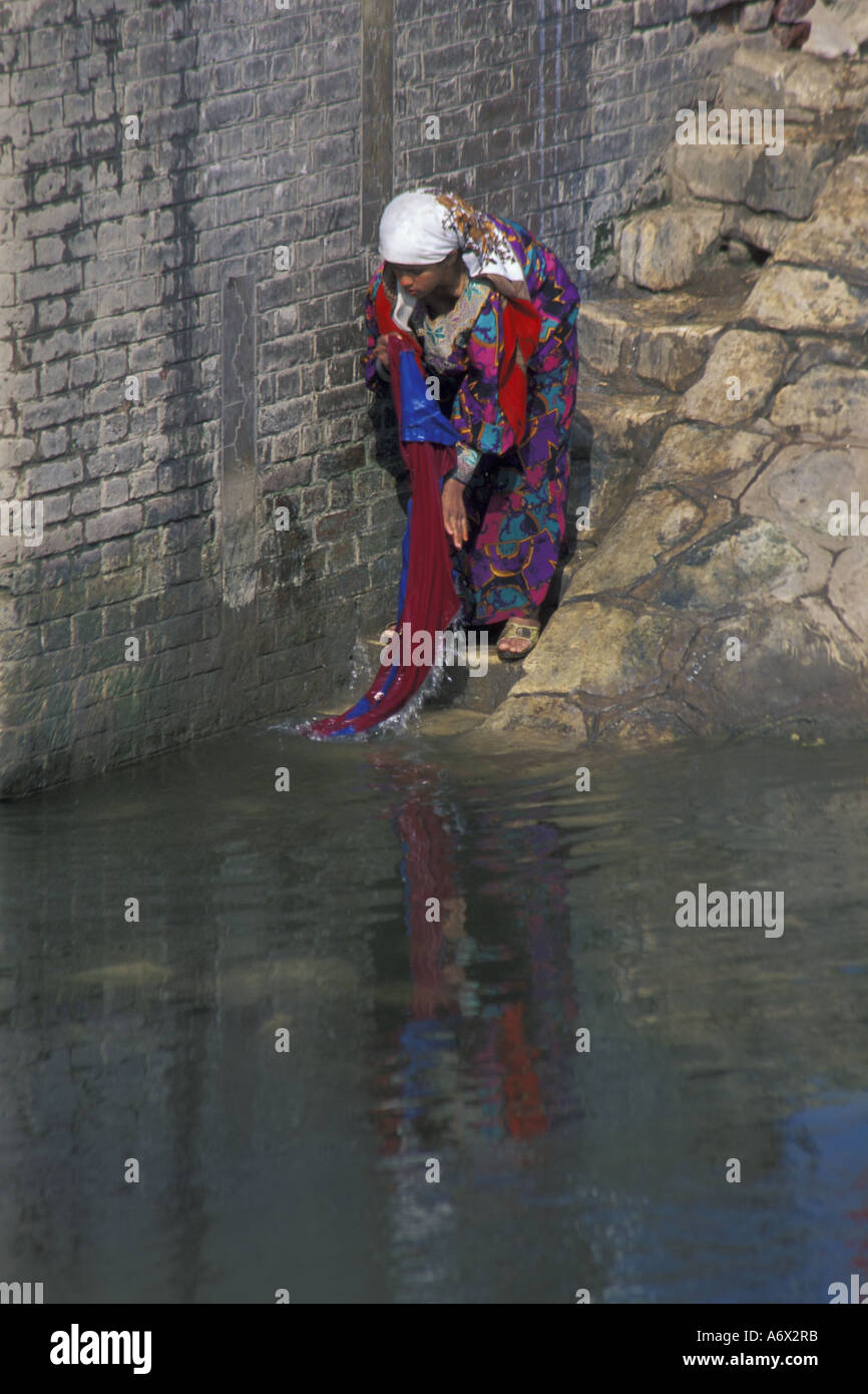 Girl Doing the Laundry at the Canal at Al Fayoum, Egypt Stock Photo - Alamy