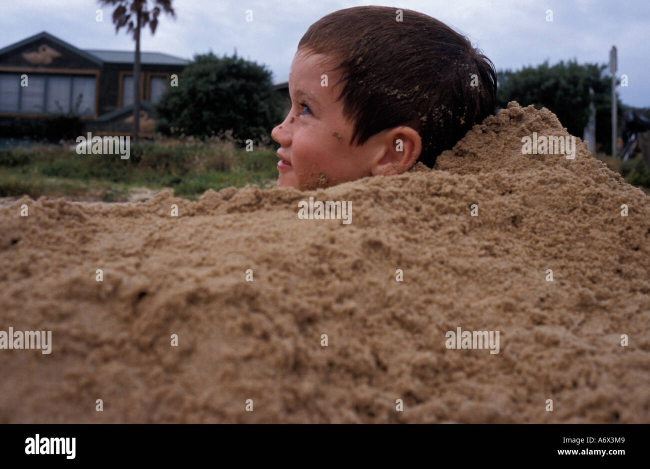 Boy Buried in Sand Sydney Australia Stock Photo - Alamy