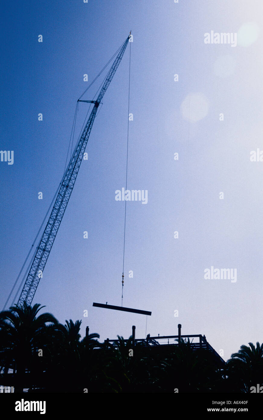 a crane lifting a heavy steel beam Stock Photo - Alamy