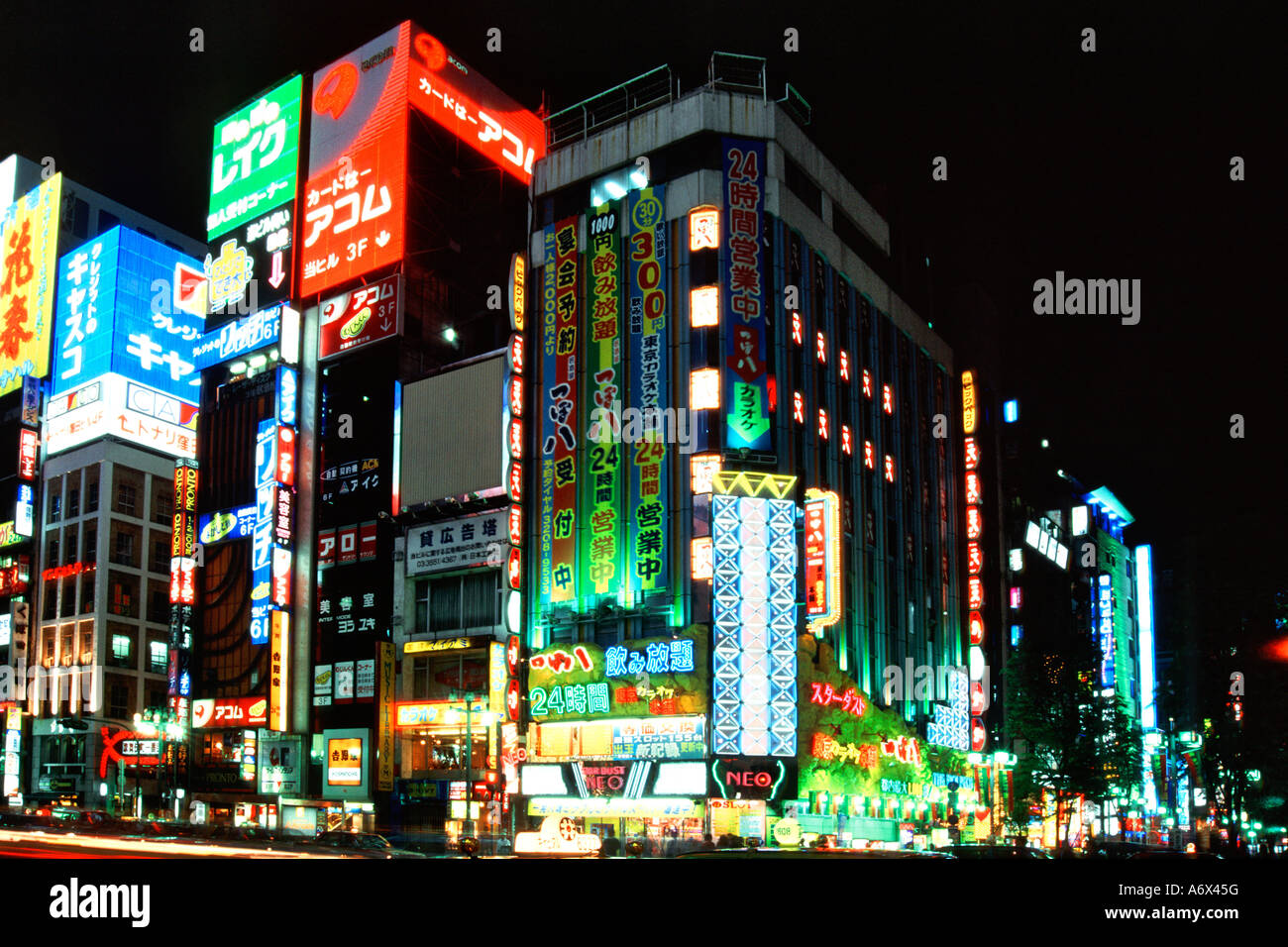 Neon signs covering buildings in Shinjuku Tokyo at night Stock Photo ...