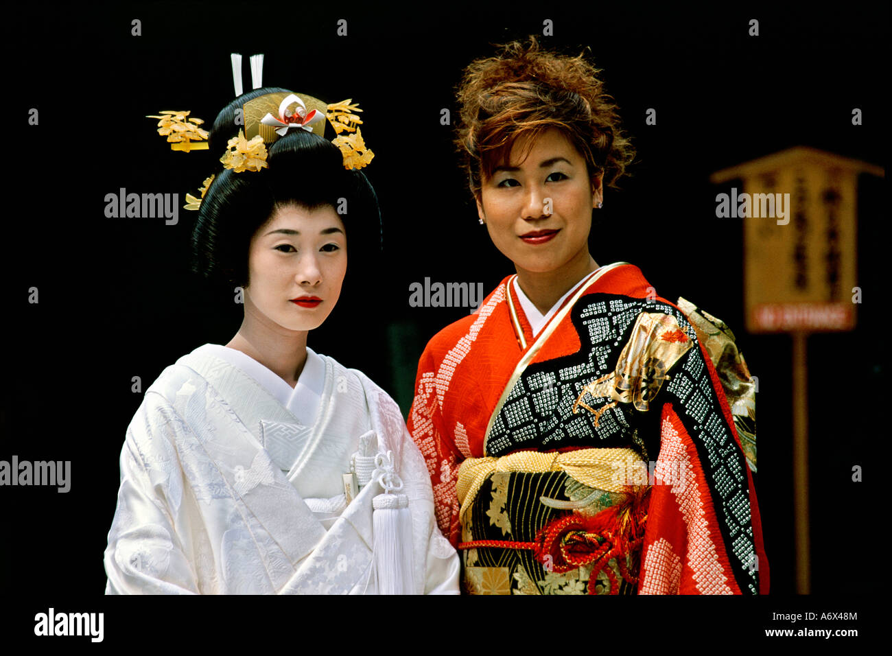 A Japanese bride poses for a photograph with a friend in the Meiji ...