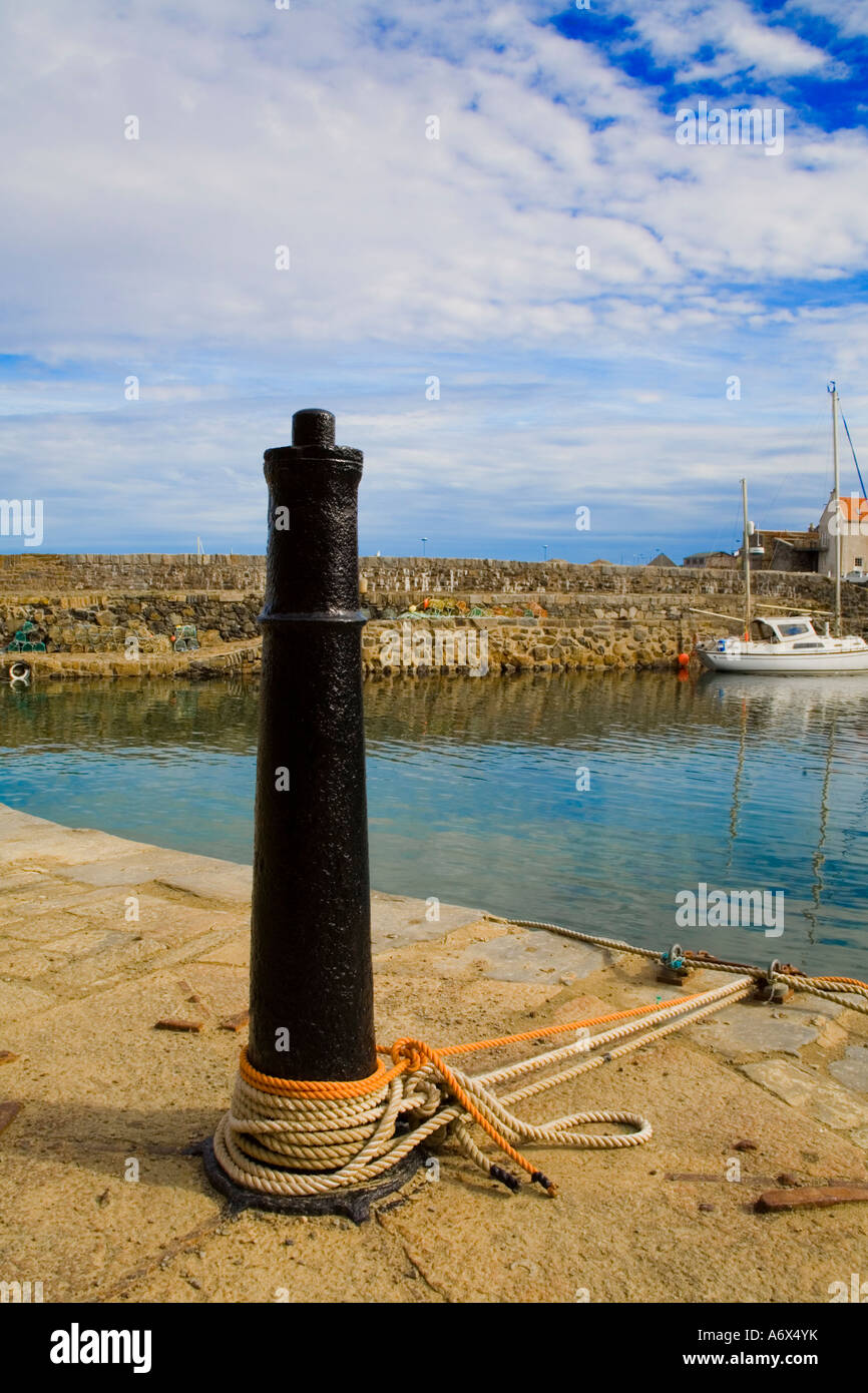 Ropes tied to a capstan at the historic 17th century Portsoy Harbour in ...