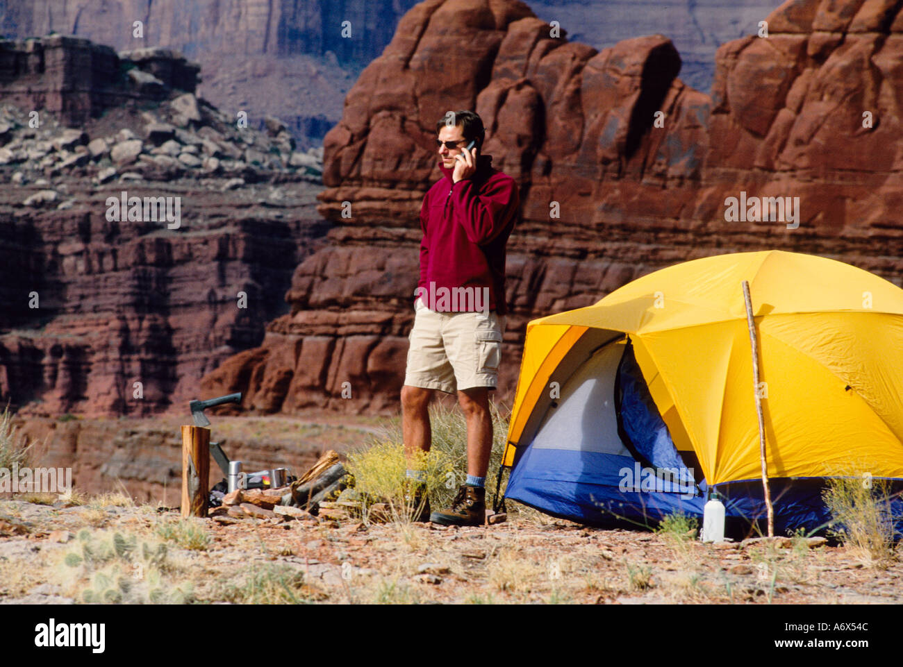 A man talking on his cell phone while camping in Canyonlands National ...