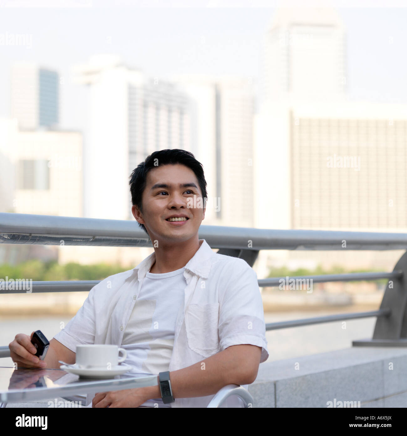 Young man, causal dress using cellular phone Stock Photo - Alamy