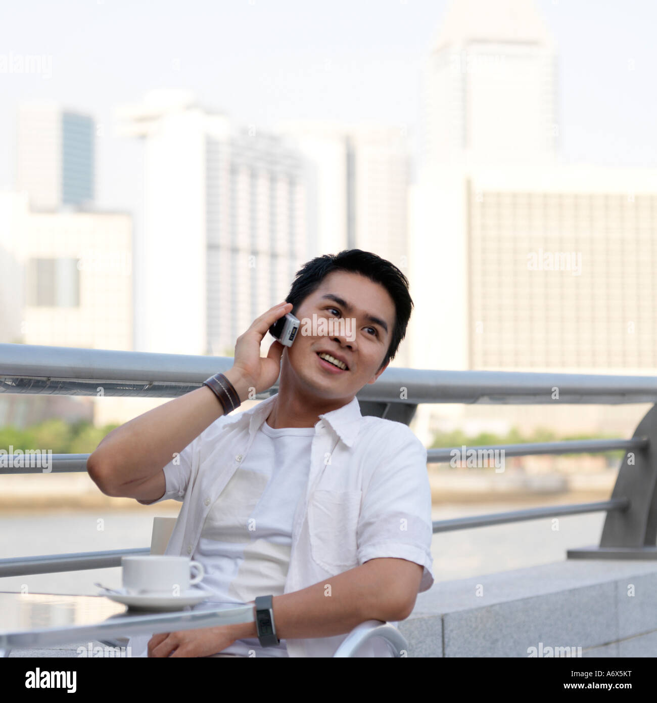 Young man, causal dress using cellular phone Stock Photo - Alamy