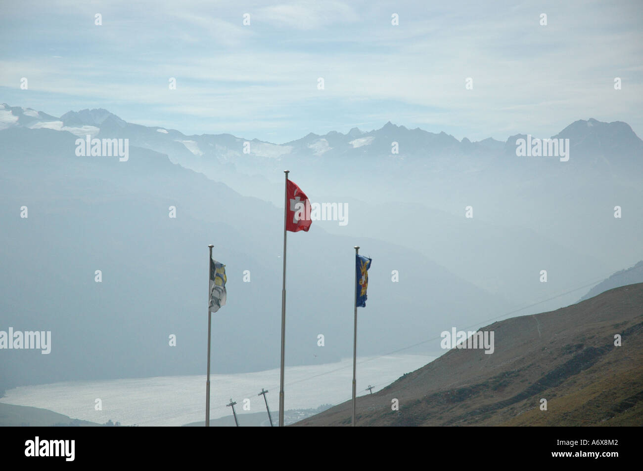 View over the Swiss Alps with Swiss flags Stock Photo - Alamy