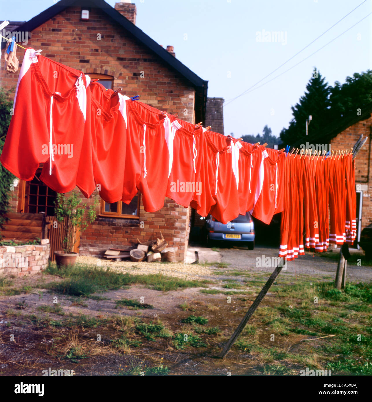 Red football socks and shorts hanging on a washing line Wales UK Stock ...