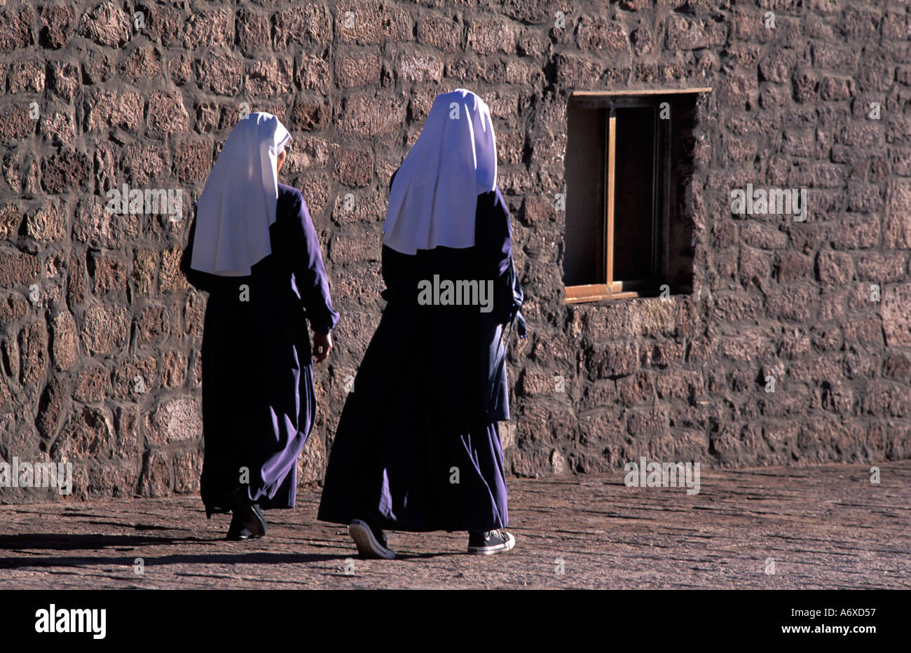 Nuns in religious vestments returning from the church to the nunnery ...