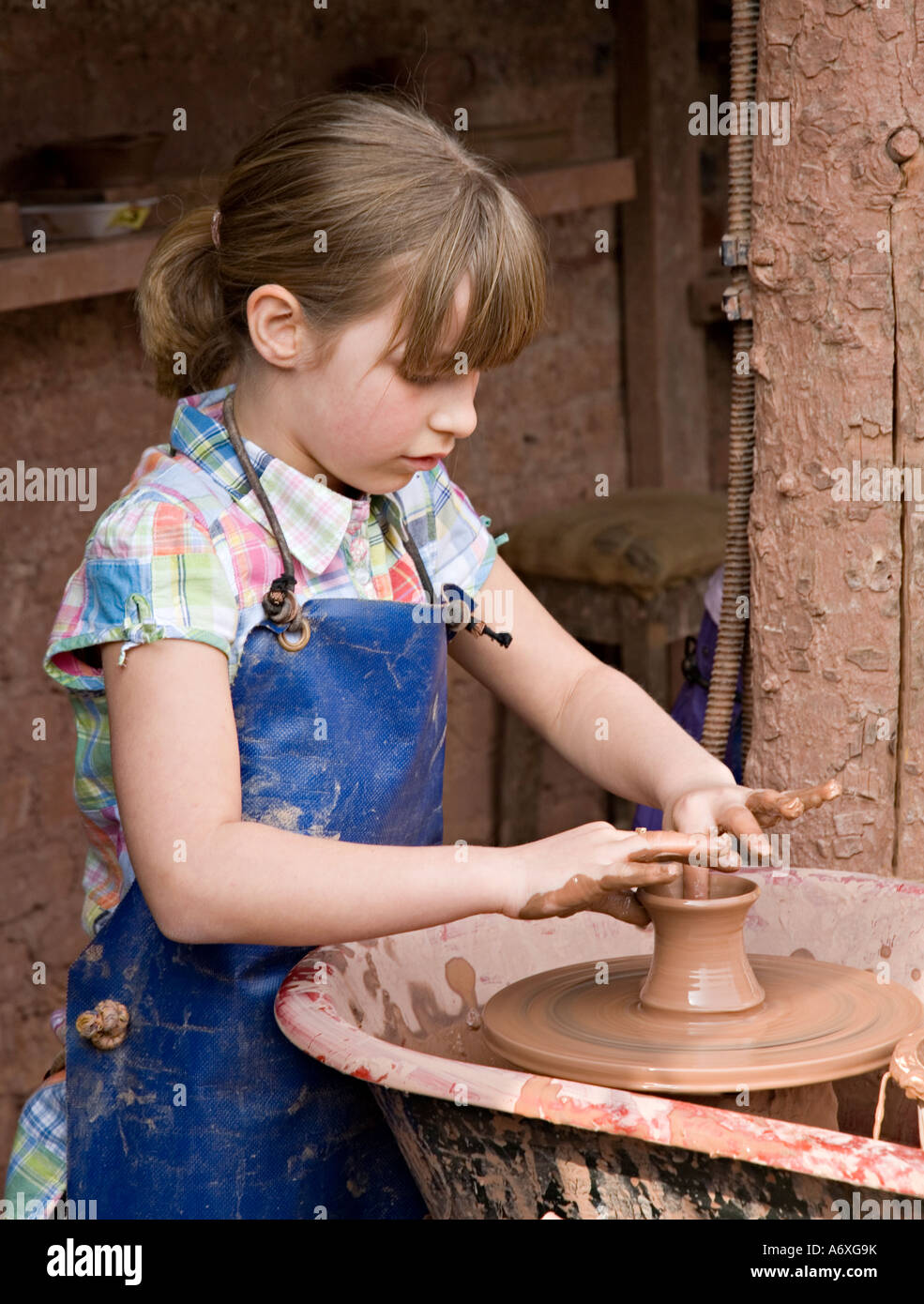 Girl throwing pot on wheel St Fagans country museum Wales UK Stock ...