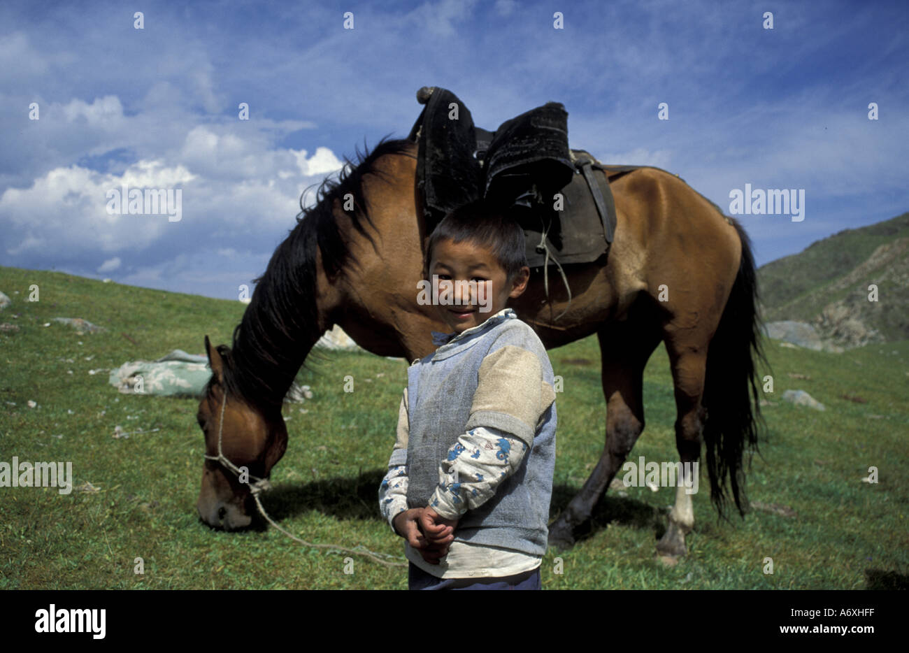 Asia, Kyrghyzstan, Altai mountain region. Kid with typical felt hat in ...