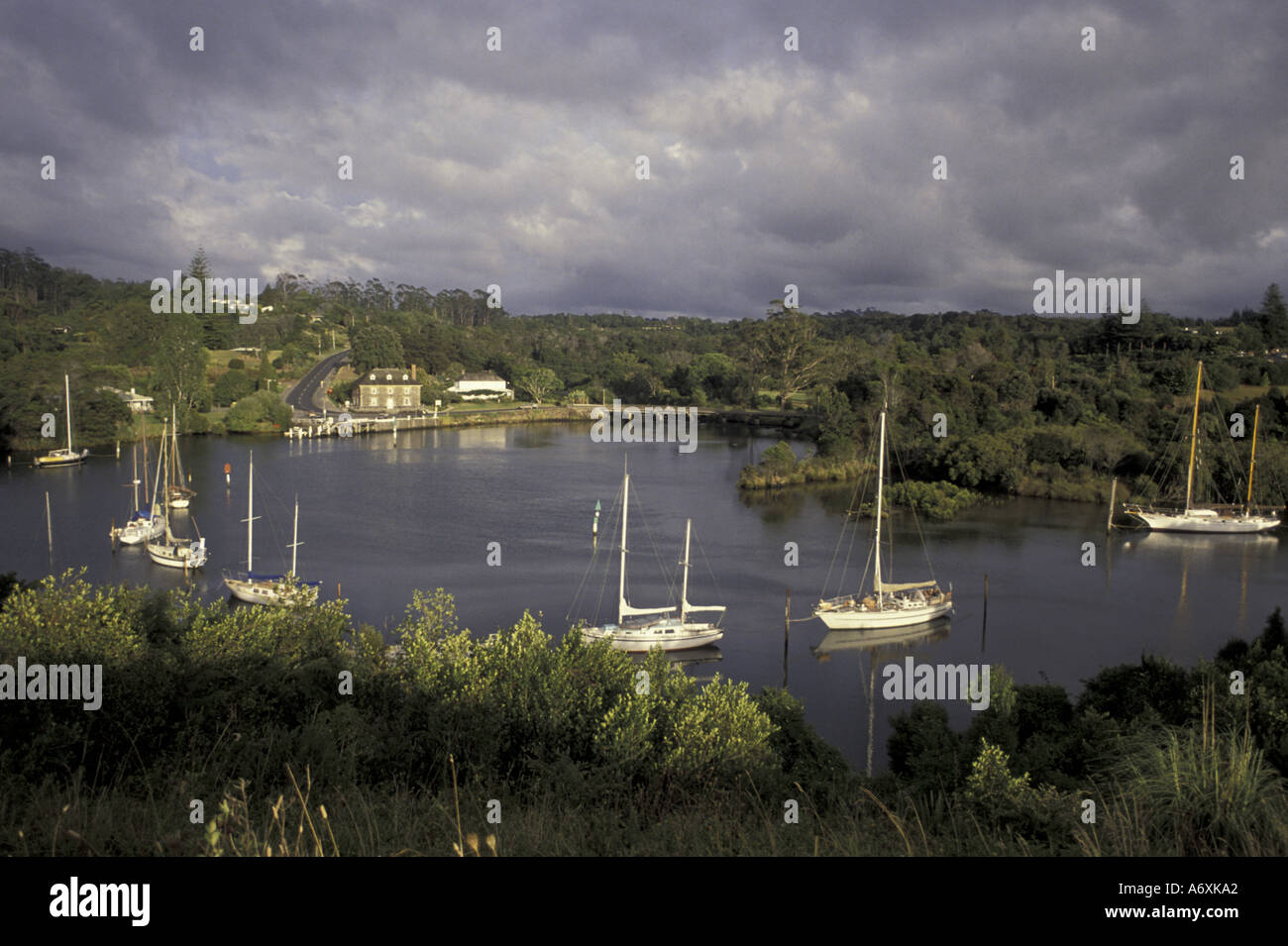 New Zealand, Bay of Islands Sailboats anchored in shallow bay ...