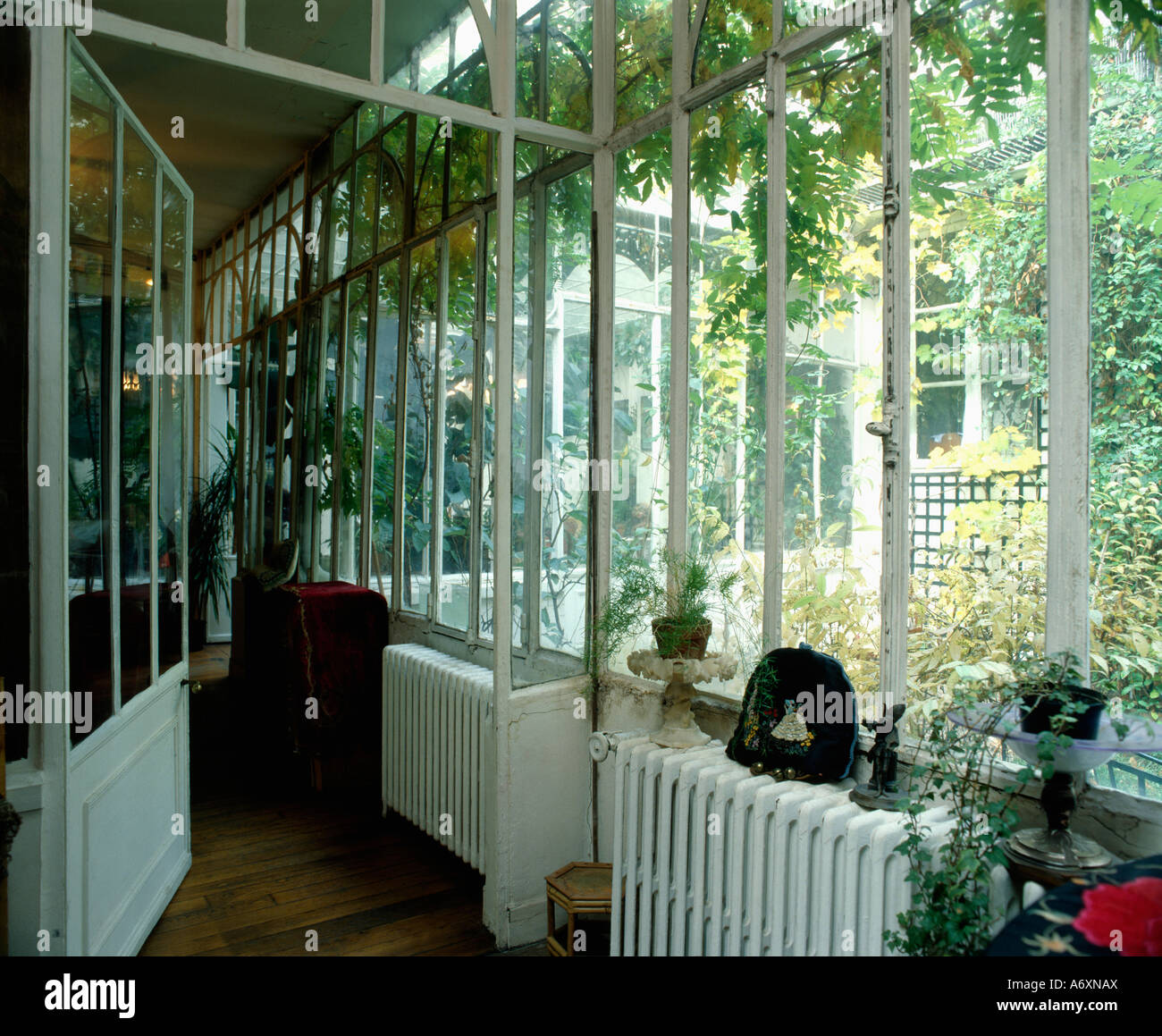 White radiator below window in conservatory hall extension with French ...
