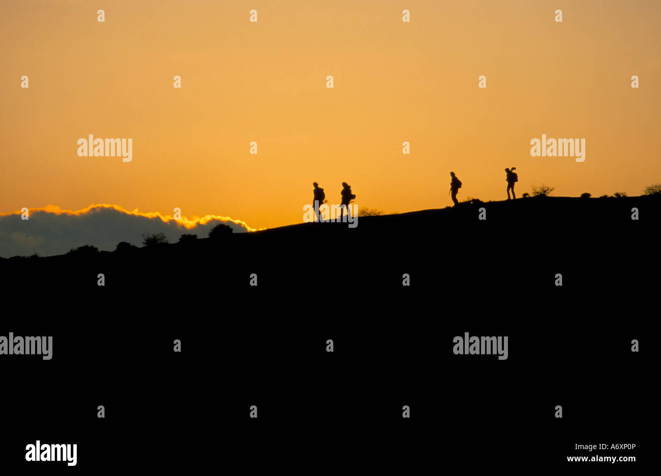 People walking at sunset on top of White House Cliffs Red Rock Canyon ...