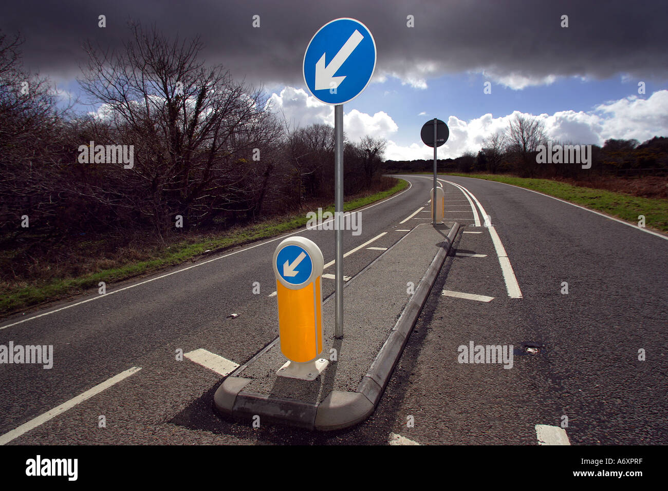 traffic island with dramatic clouds and blue sky Stock Photo - Alamy